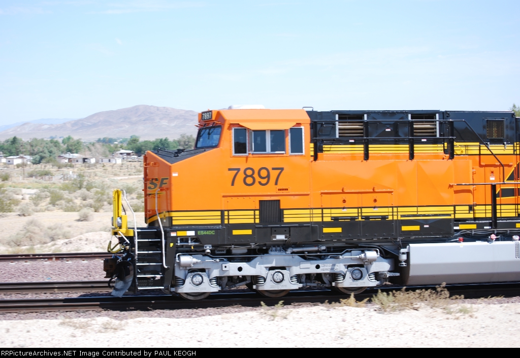 Side shot of the cab of a Brand New ES44DC BNSF 7897 as she rolls west out of BNSF Barstow with ...